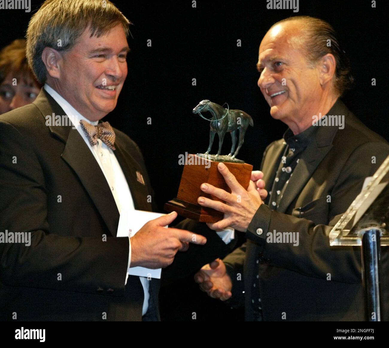 Managing partner of Funny Cide, Jack Knowlton, left, accepts the award ...