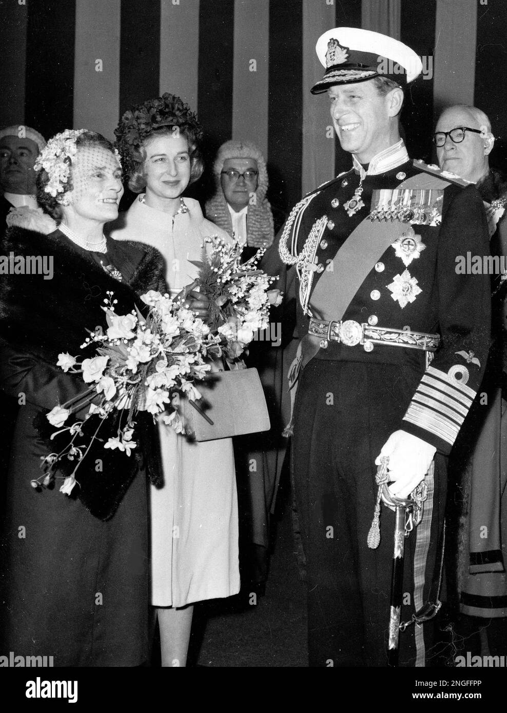 Britain's Princess Alice the Duchess of Gloucester, left, shares a joke ...