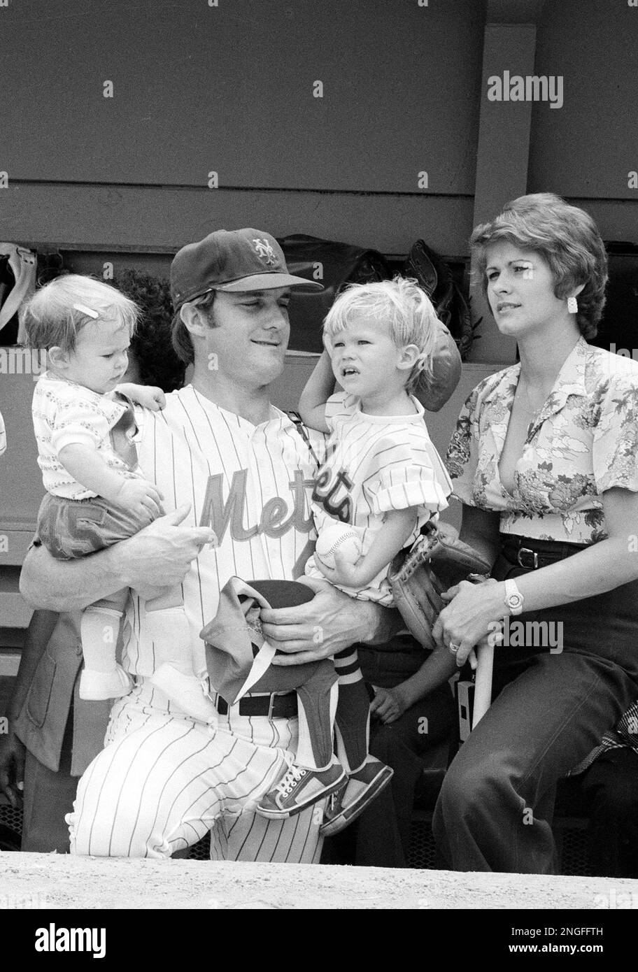 Tug McGraw of the New York Mets has his arms full during players family ...