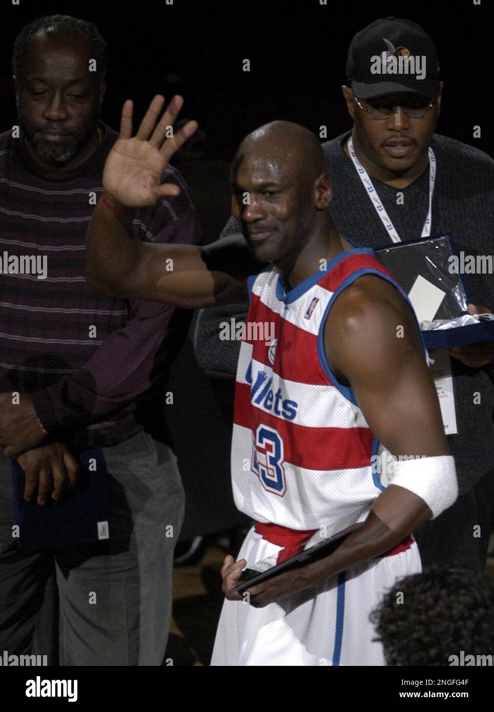 Washington Wizards' Michael Jordan waves to the crowd as he walks off ...