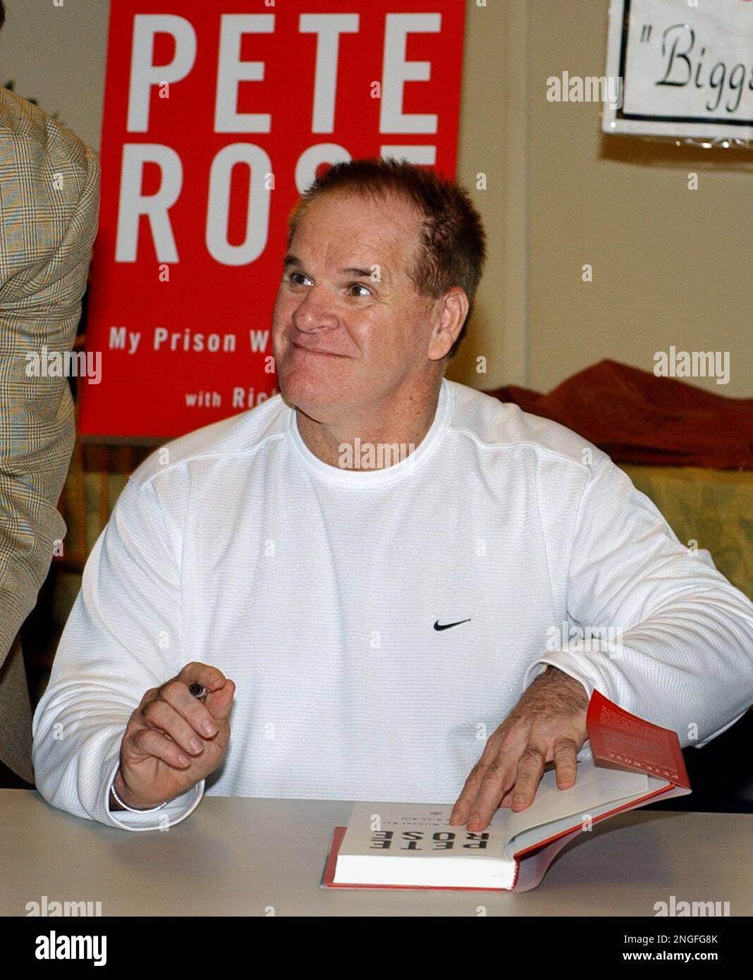 Pete Rose smiles as he signs a copy of his book, "My Prison Without ...