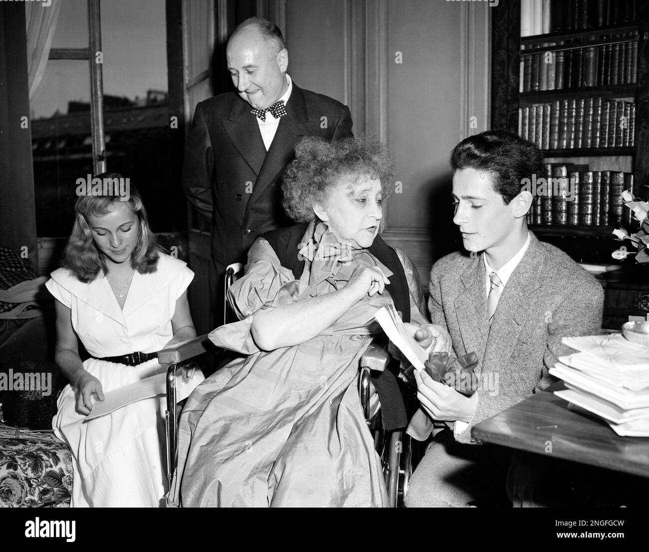French director Claude Autant-Lara, standing, presents a film script to ...