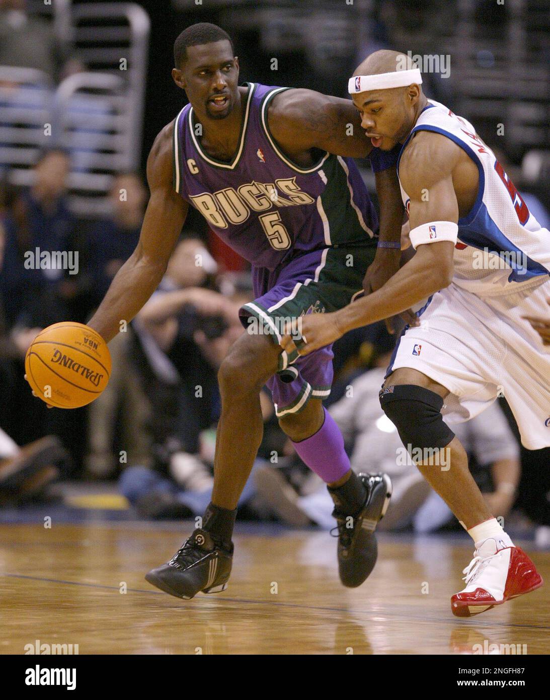 Milwaukee Bucks' Tim Thomas, left, brings the ball up after stealing it ...