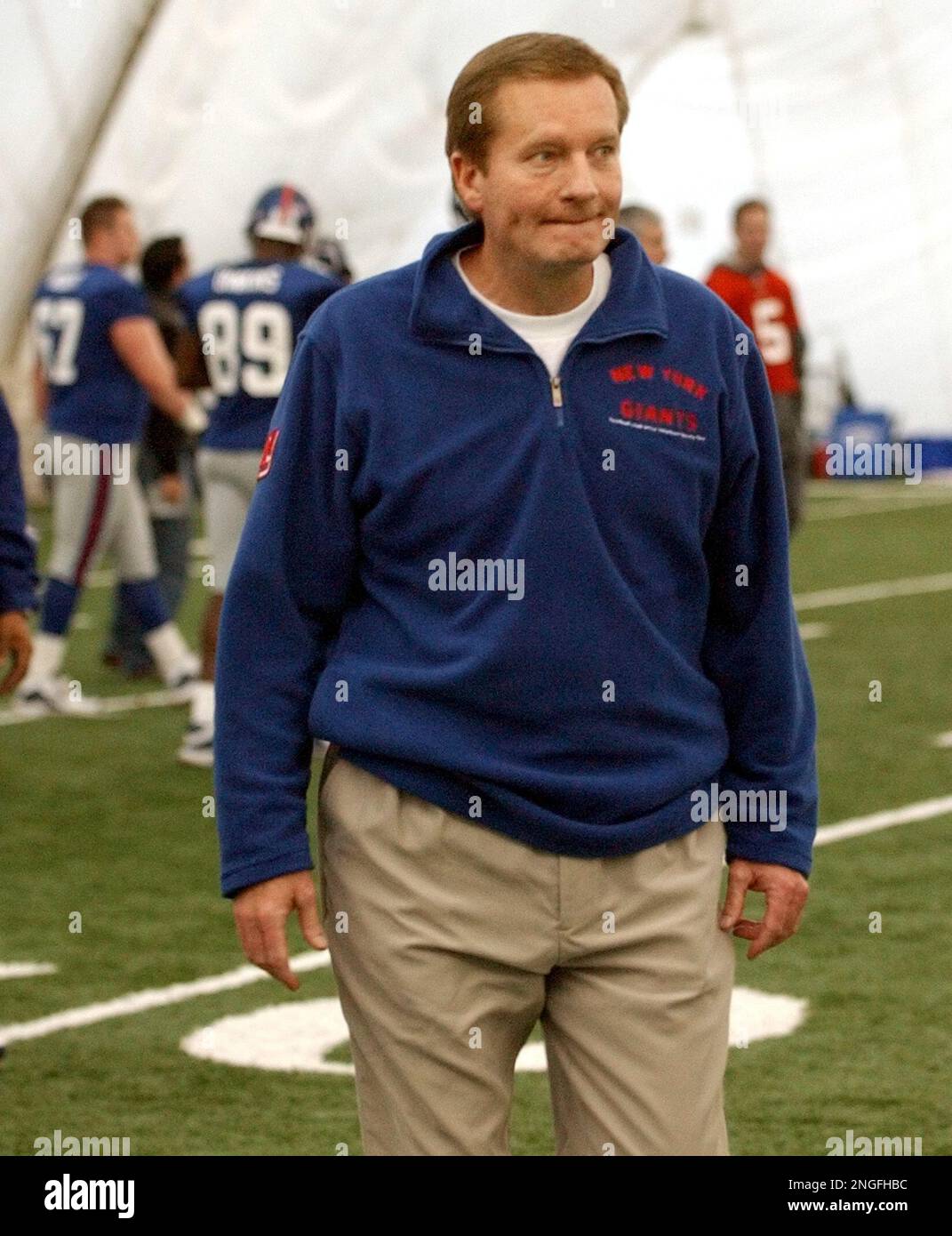 New York Giants coach Jim Fassel leaves the field after practice as he ...