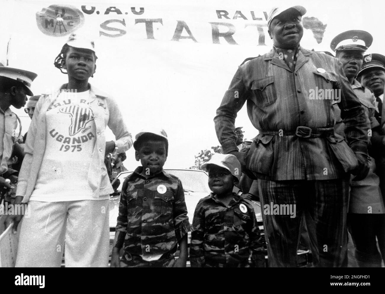 Ugandan President Idi Amin stands with his two sons, Aliga, 4, and ...
