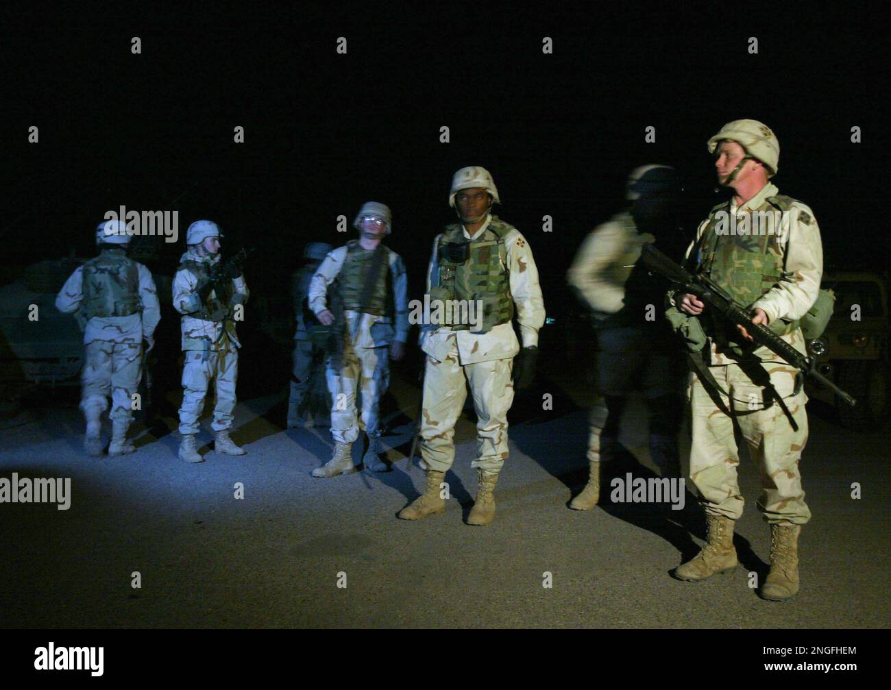 U.S. soldiers block the road linking to Saddam Hussein's underground ...