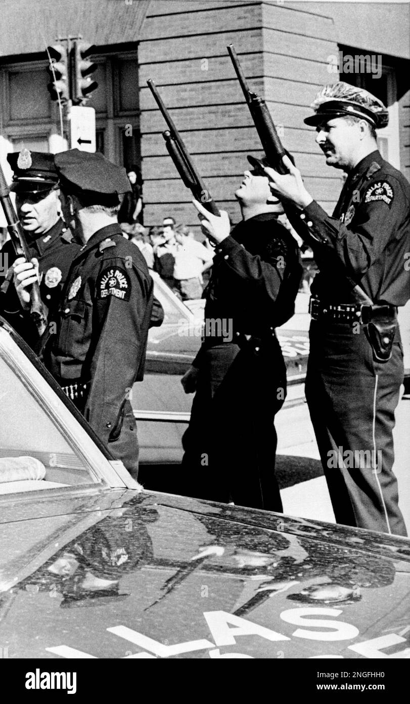 Police officers with guns ready look up the building where the shot ...