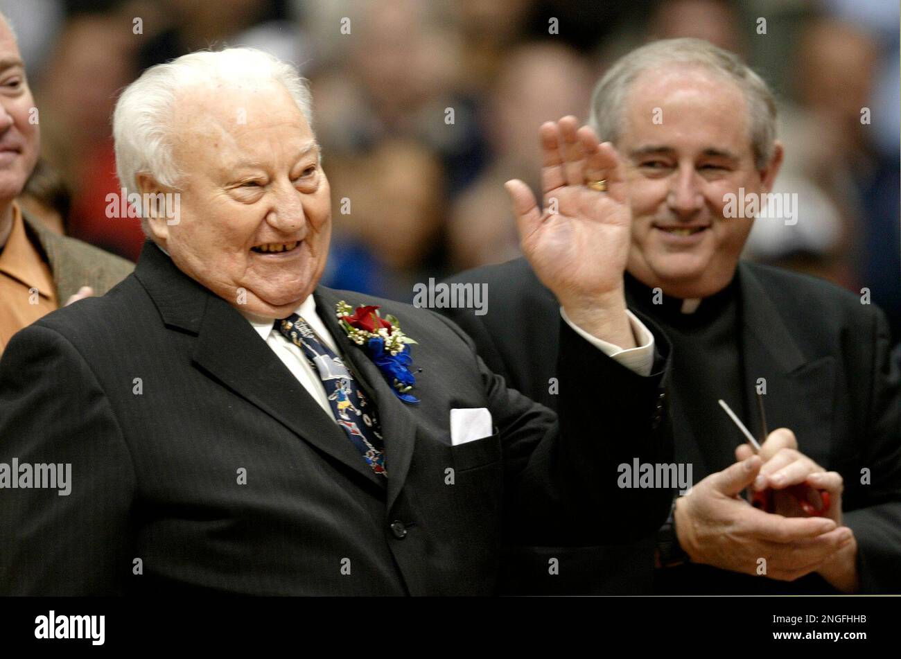 Former DePaul head basketball coach Ray Meyer, left, waves as the crowd ...