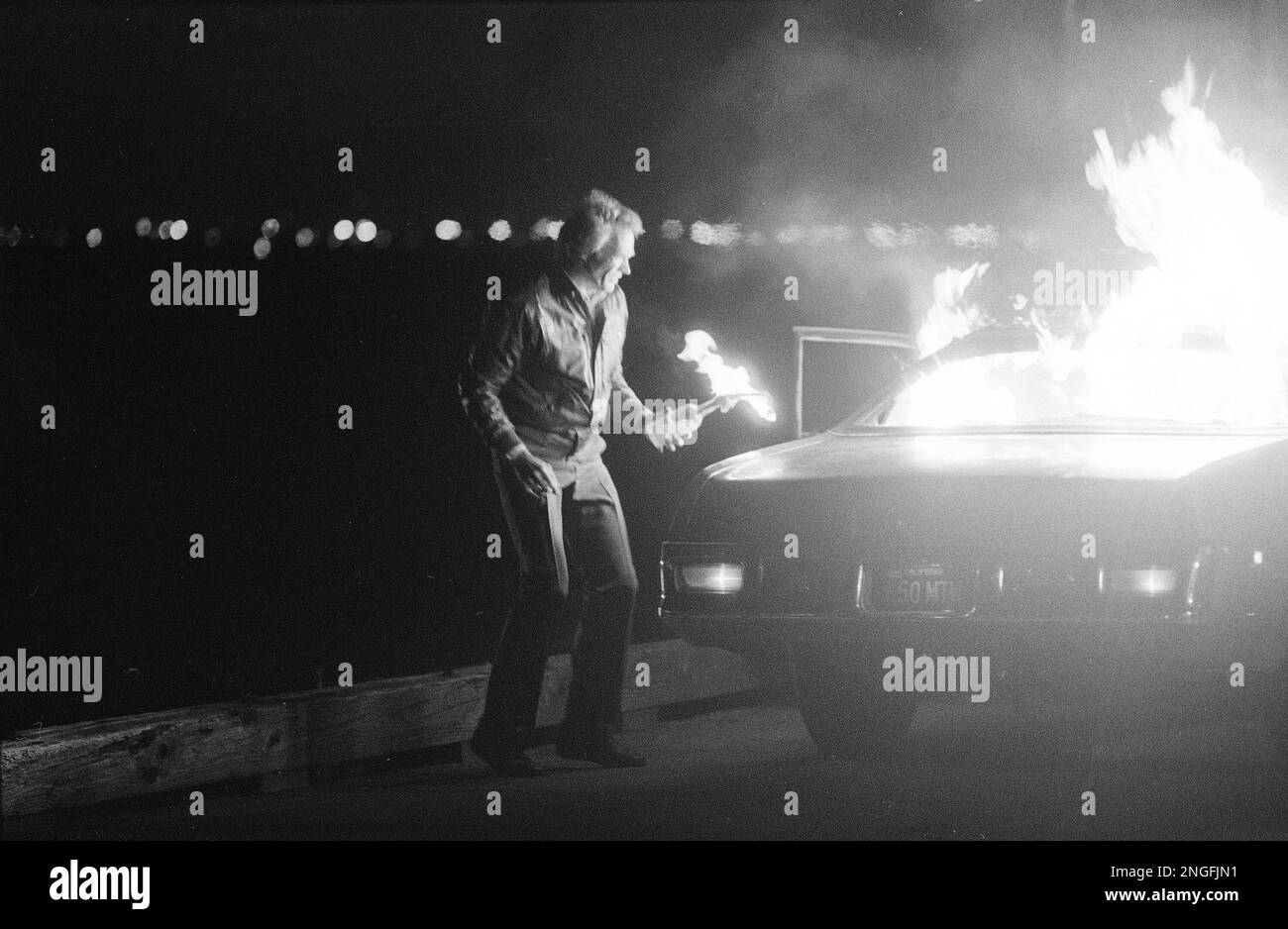 Actor Clint Eastwood, as detective Harry Callahan, gets ready to throw ...