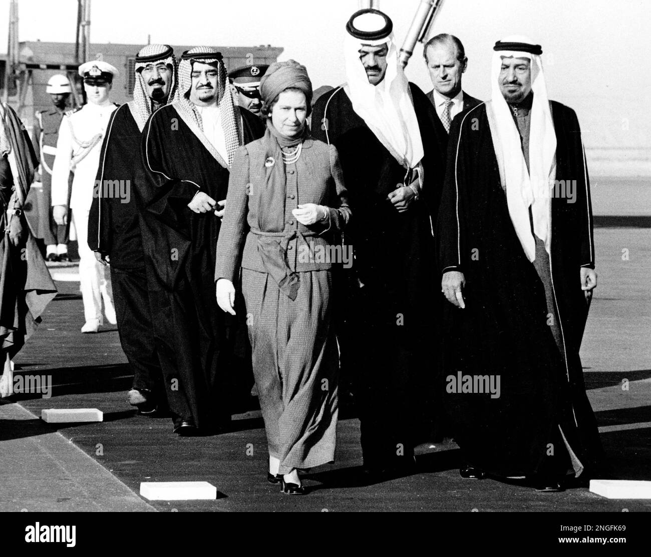 Britain's Queen Elizabeth II is escorted by King Khali of Saudi Arabia ...