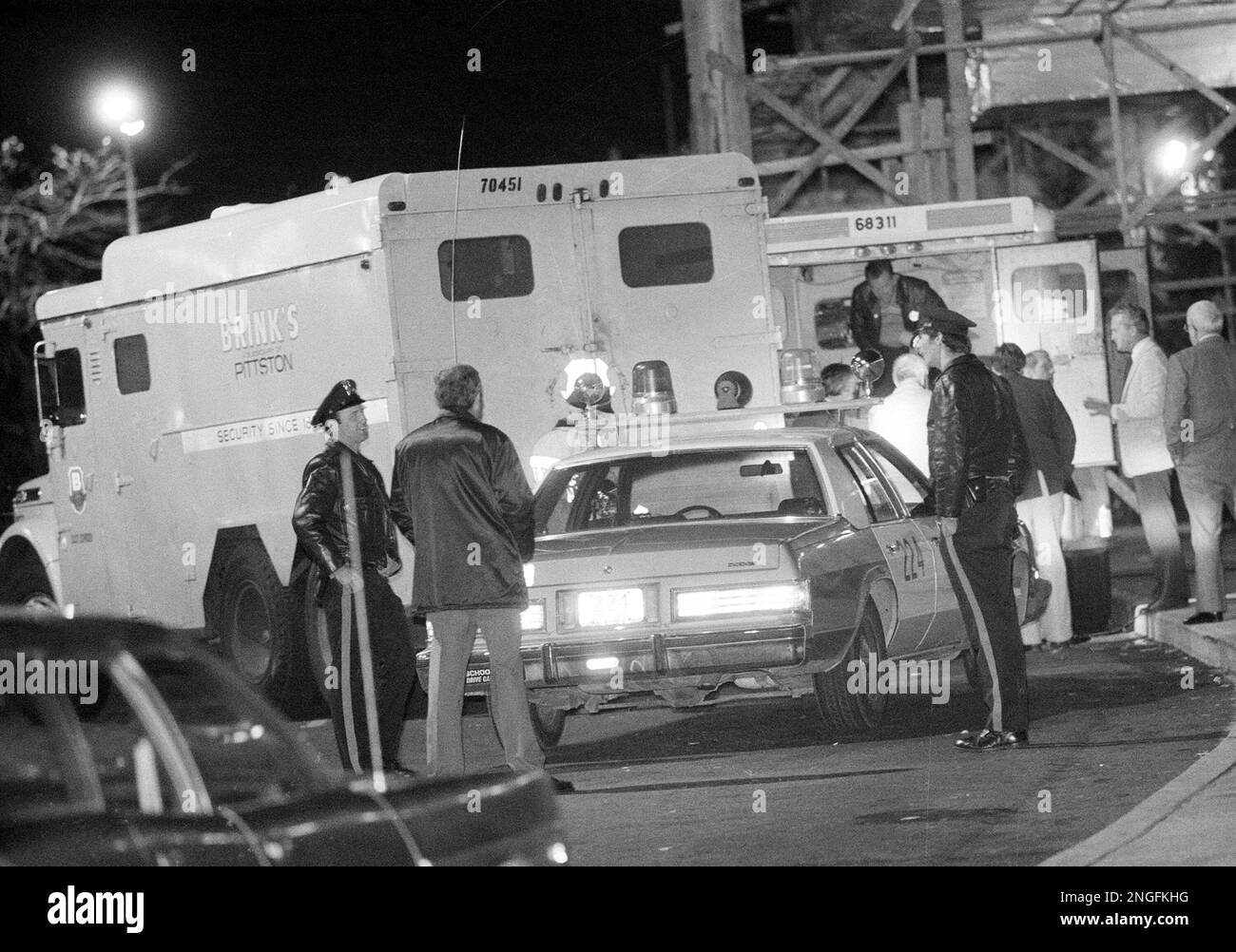 Police are at the scene of a Brinks armored truck after a robbery at ...