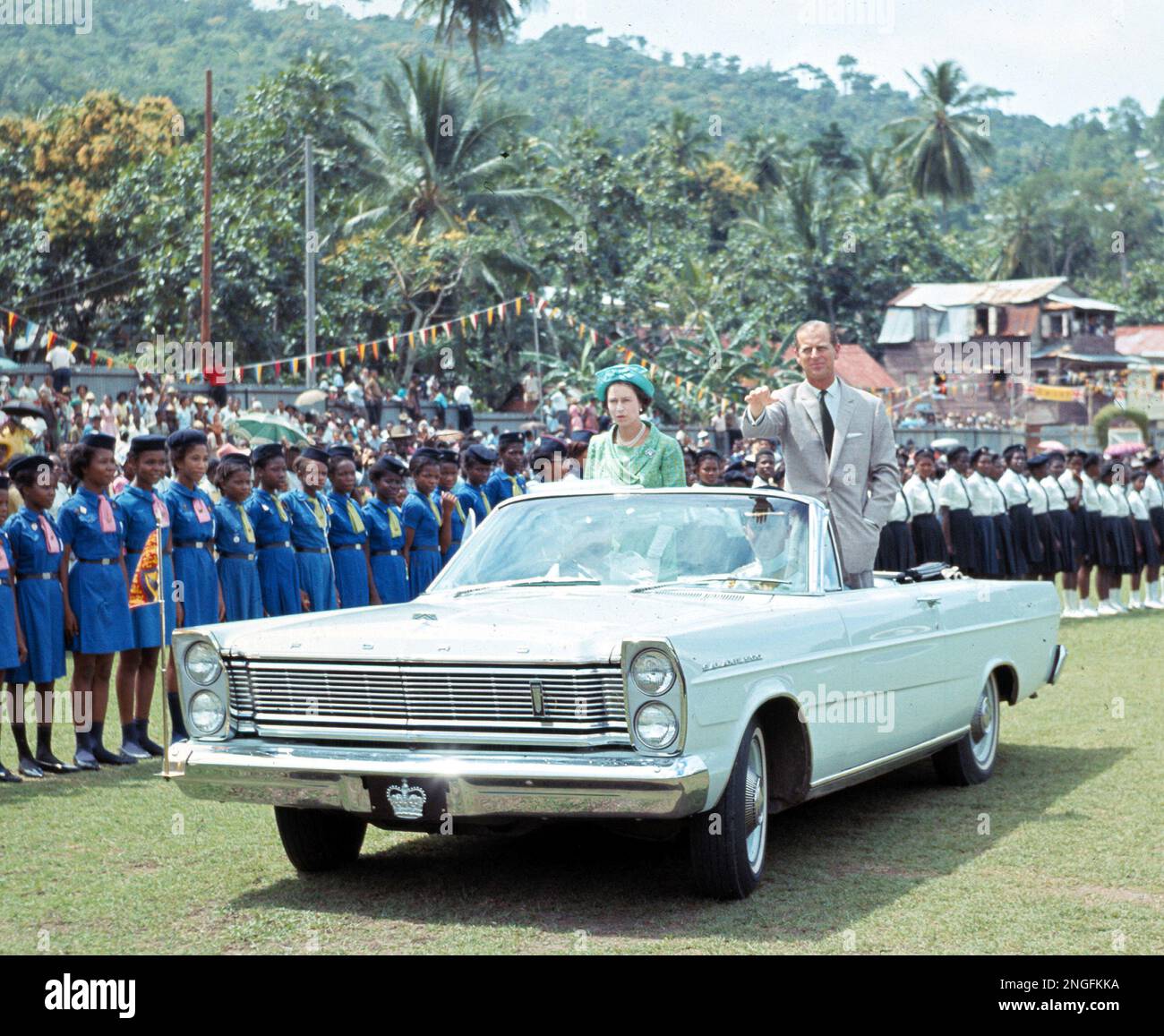 Britain's Queen Elizabeth II and her husband Prince Philip are driven ...
