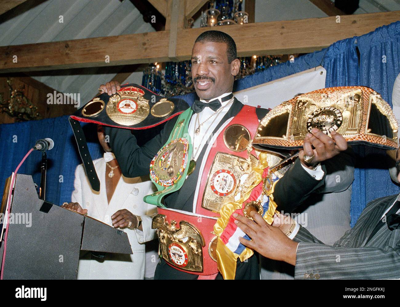 Heavyweight boxer Michael Spinks displays his championship belts at a ...