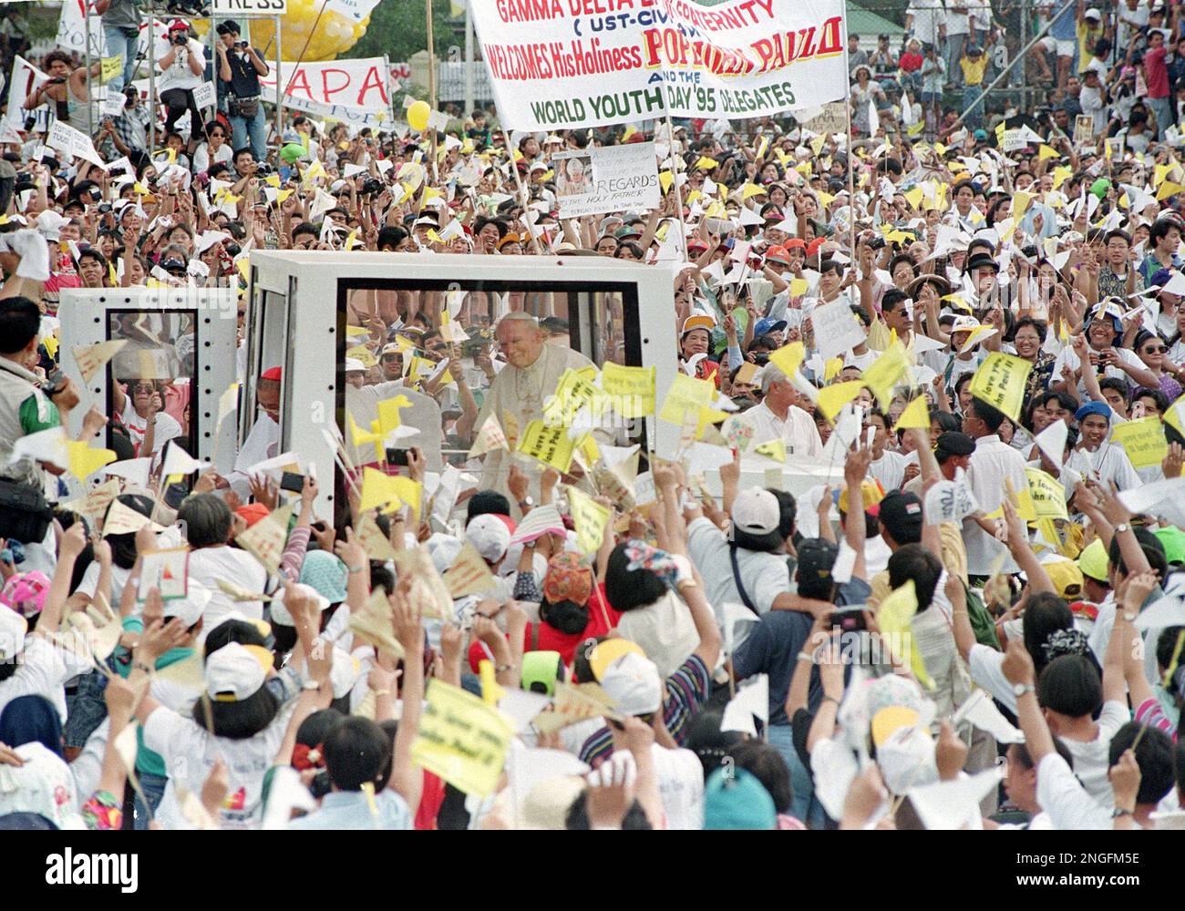 The bullet-proof vehicle carrying Pope John Paul II is surrounded by ...