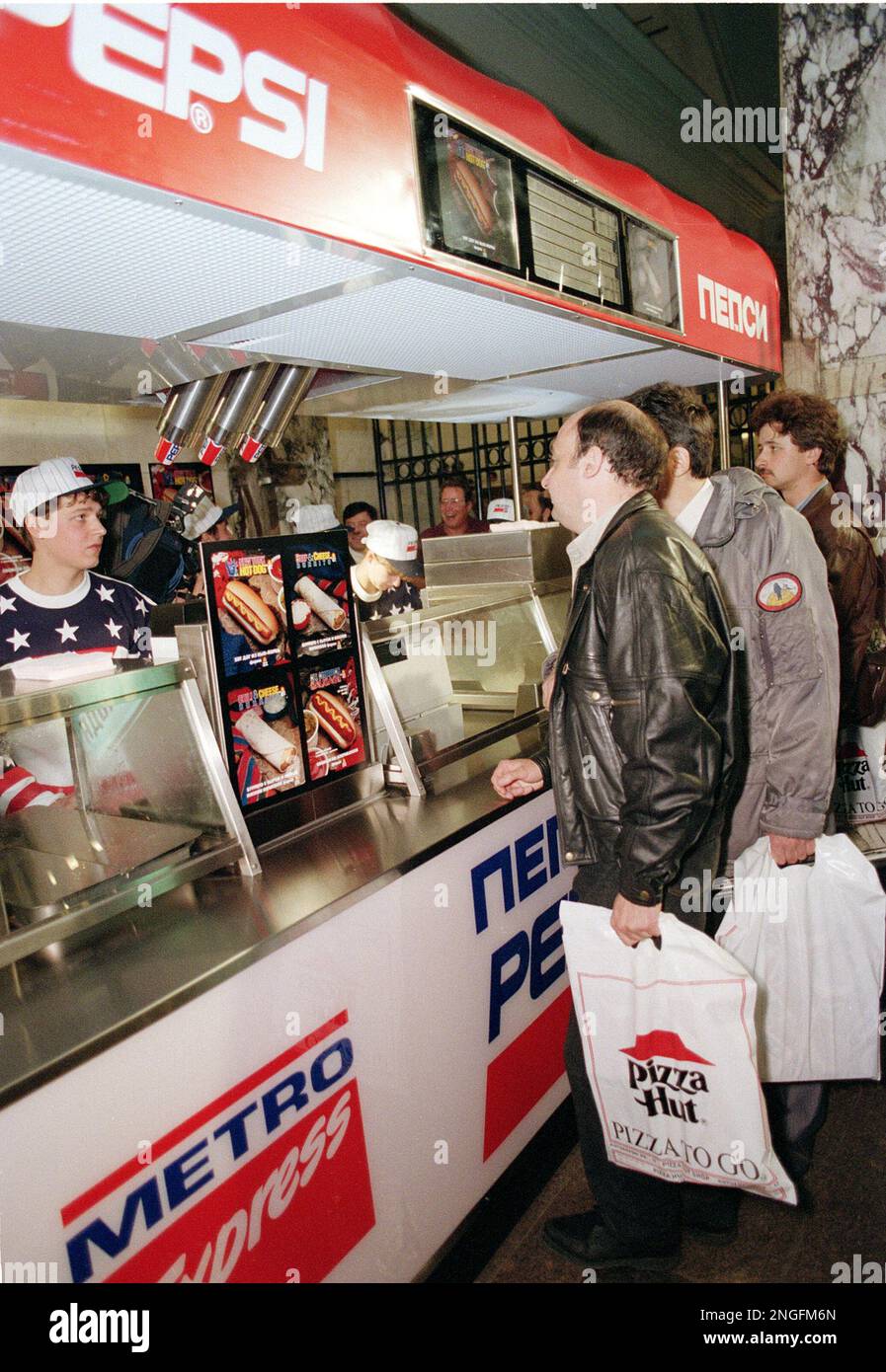 Commuters stand in line at Pepsi's new Metro Express booth in Moscow's ...