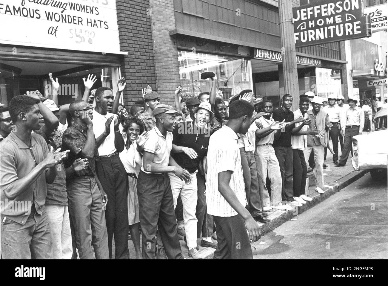 Young black protestors are cheering and clapping hands as they stand ...