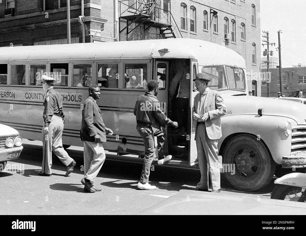 Black demonstrators are led away to jail in a school bus, after the ...