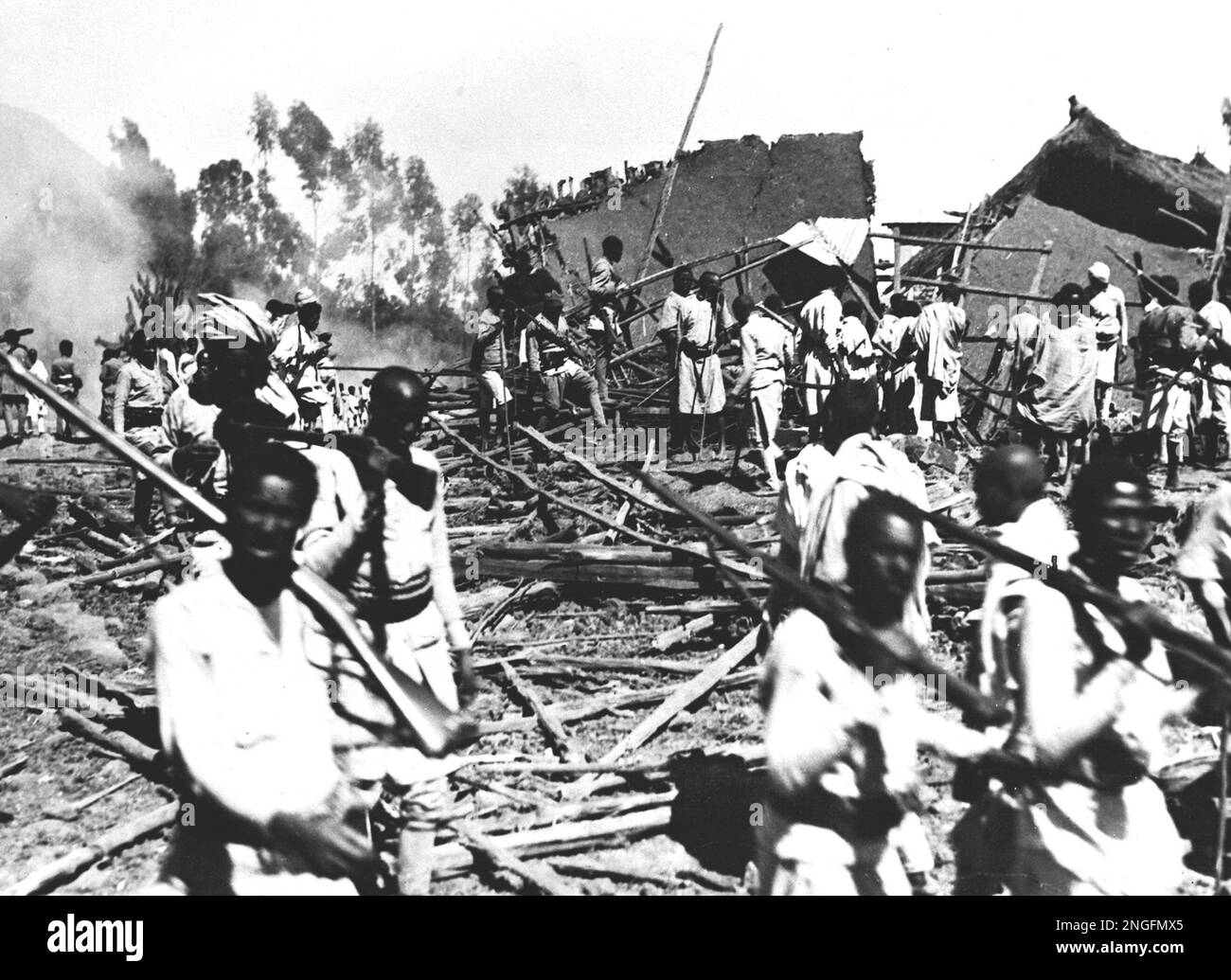 Abyssinians search the smouldering debris of wrecked homes following an ...