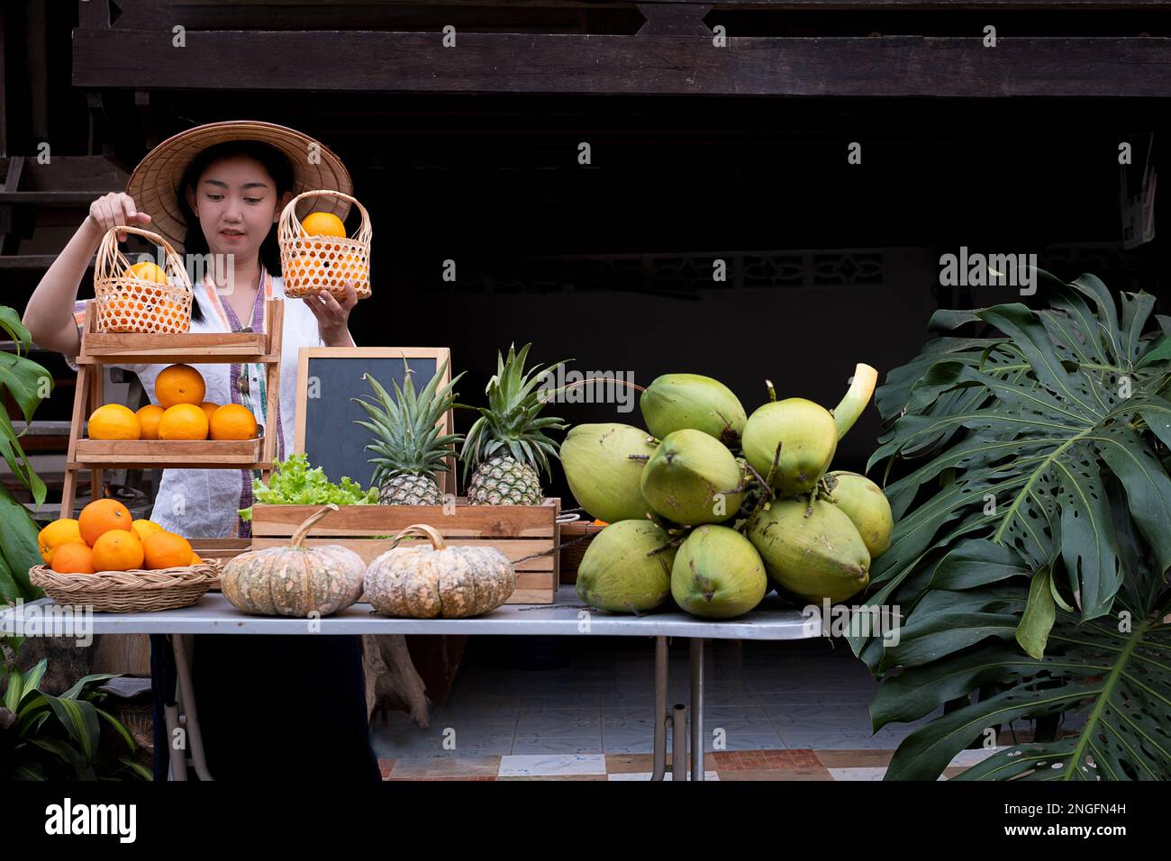 Native Asia woman selling natural variety of fruits at the farm stay ...