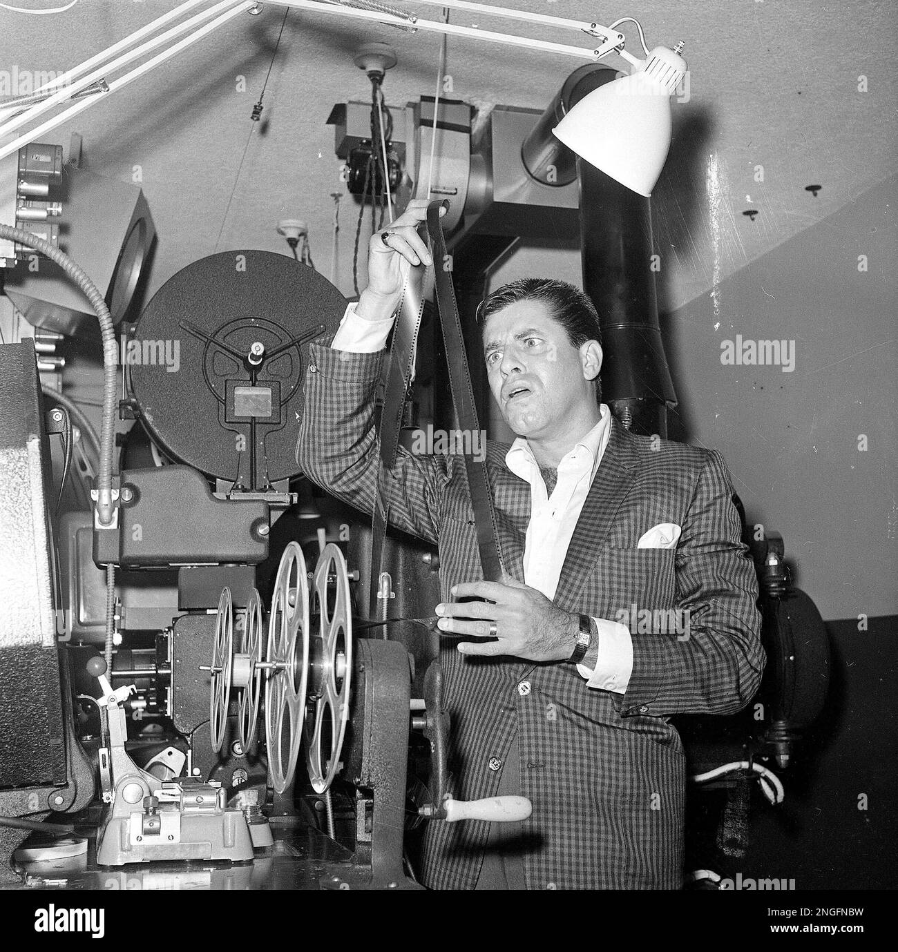 Comedian Jerry Lewis is shown in the projection and cutting room of his ...