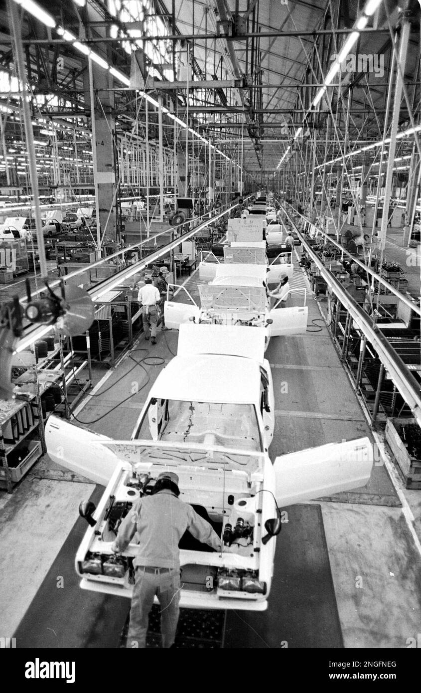 Cars move down an assembly line at a plant operated by Nissan, in ...