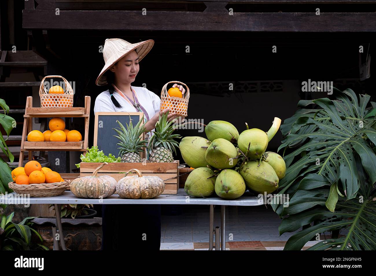Native Asia woman selling natural variety of fruits at the farm stay ...