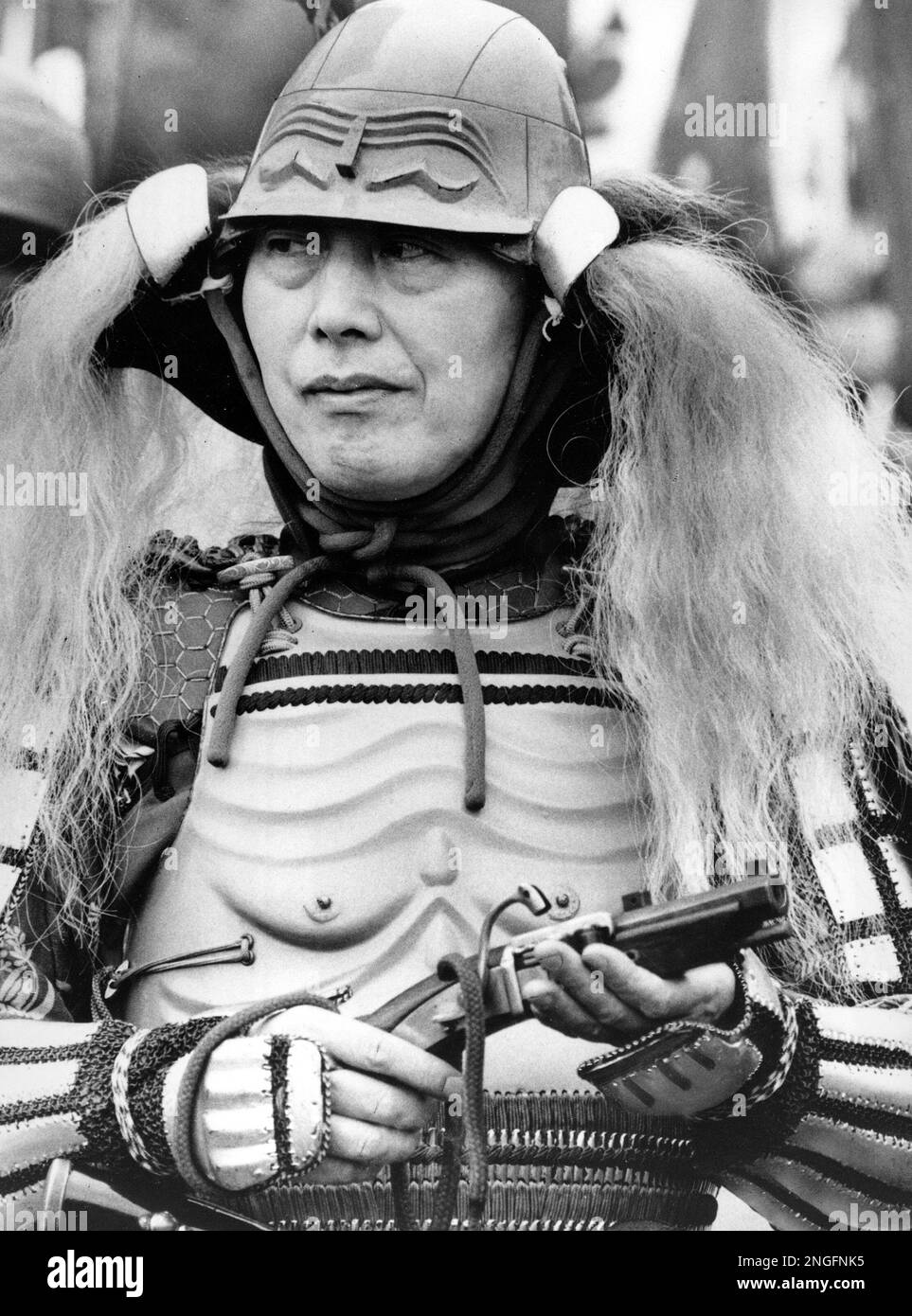 A member of the "Hundred Gunmen" wears a replica samurai armor and ...
