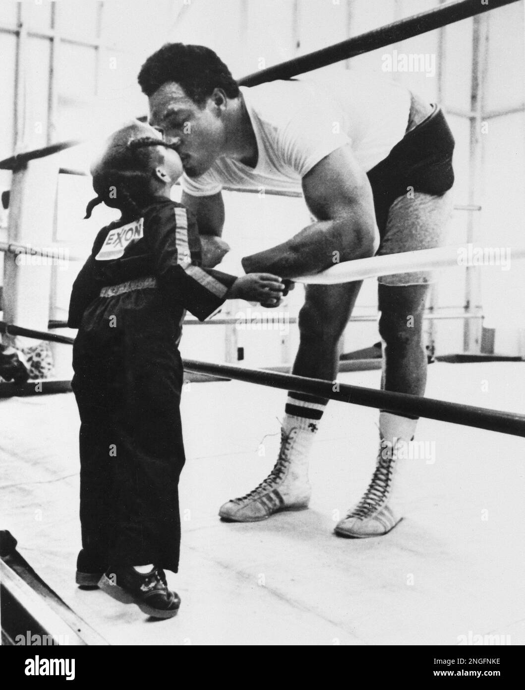 Former world boxing champion George Foreman gets a big kiss from his 3 ...