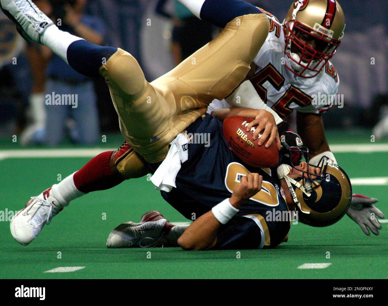 St. Louis Rams quarterback Mark Bulger, forground, is sacked by San ...