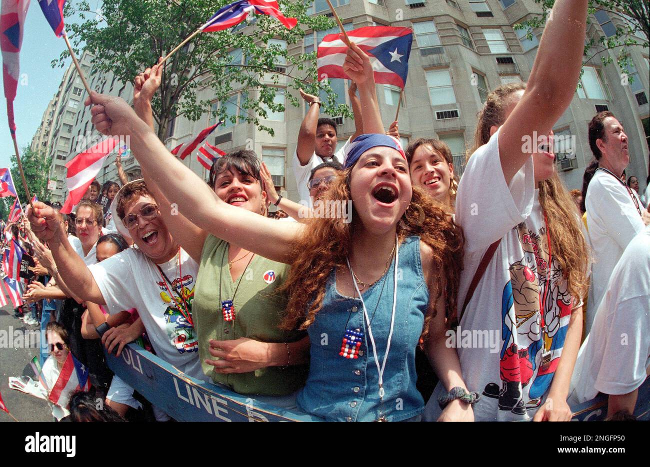 Revelers wave Puerto Rican flags during the Annual Puerto Rican Day ...