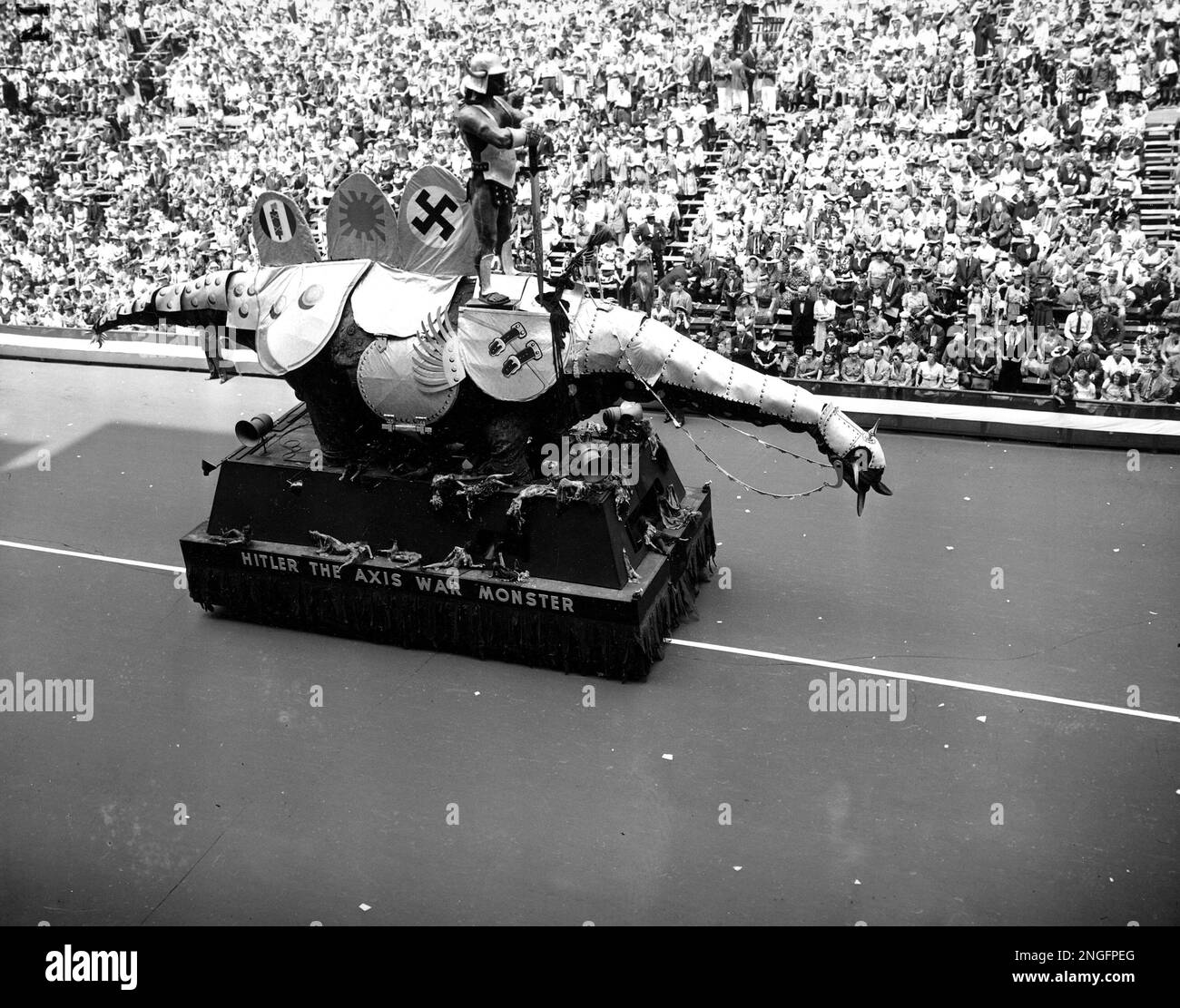 A float depicting Hitler as the Axis War Monster, with bodies of ...