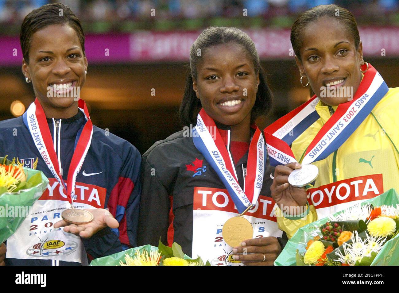 Perdita Felicien of Canada, center, displays the gold medal she won in ...