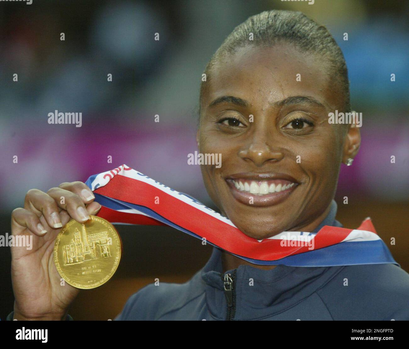 Kelli White of the U.S. displays her gold medal during the presentation ...