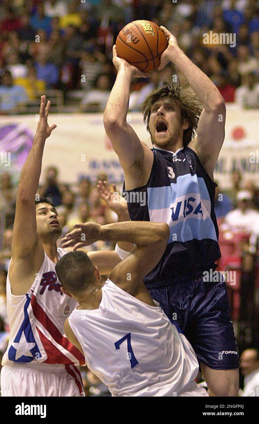 Andres Nocioni of Argentina, right, shoots past Jose Ortiz, left, and ...