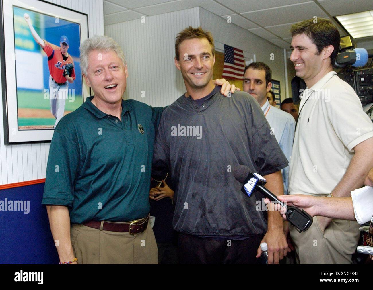 Former President Bill Clinton, left, puts his arm around New York Mets ...