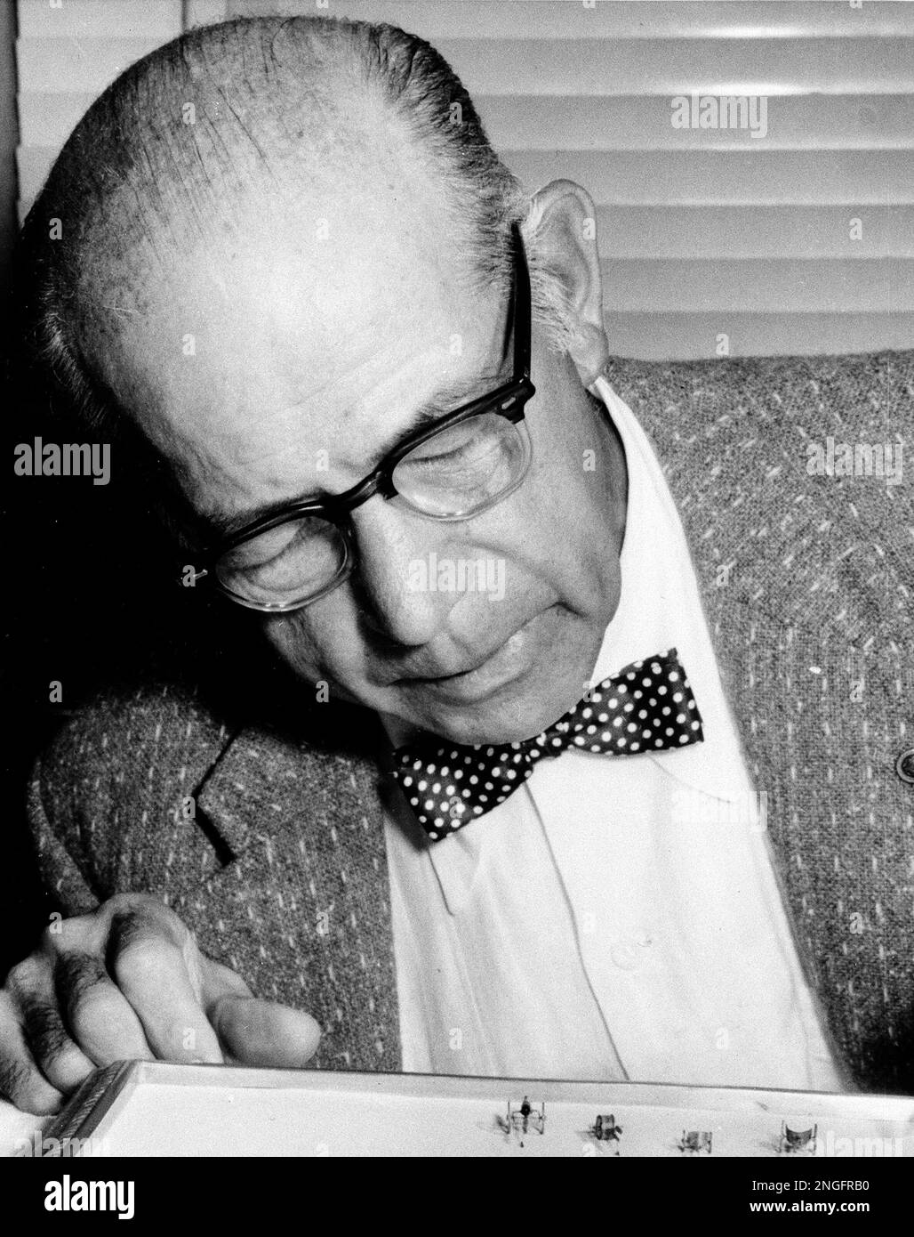 Roy Herbert Heckler, impresario of a flea circus, lines up his tiny ...