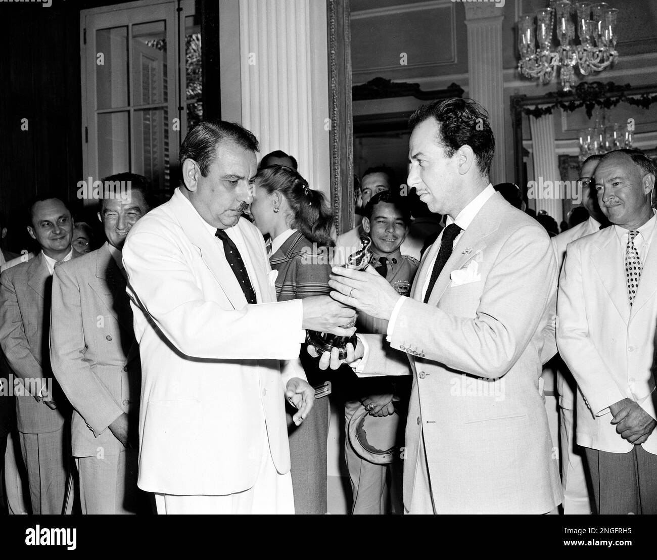 Governor of Puerto Rico Luis Munoz Marin, left, presents actor Jose ...