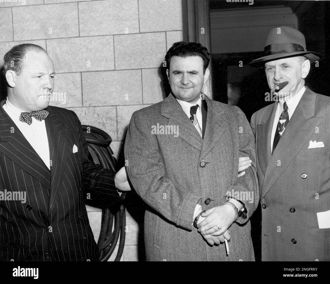 A handcuffed David Greenglass is escorted by U.S. Deputy Marshall ...