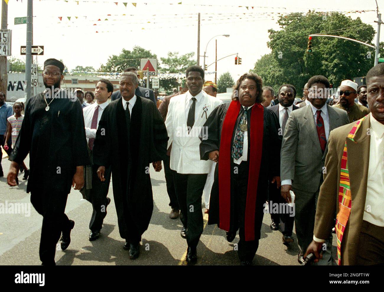 The Rev. Al Sharpton, fourth from left, wearing long scarf, walks in a ...