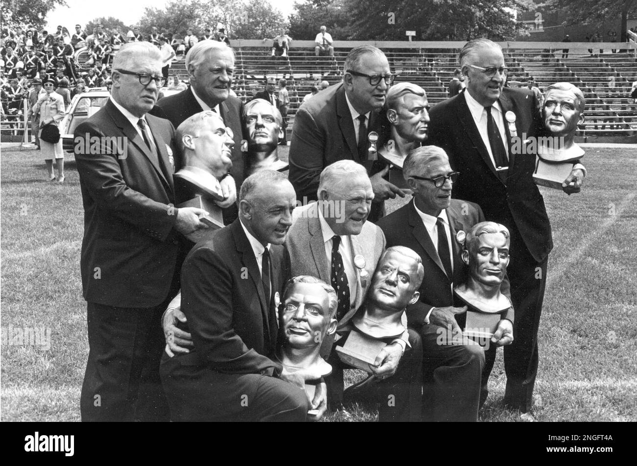 Seven gridiron greats pose with their busts after being inducted into ...