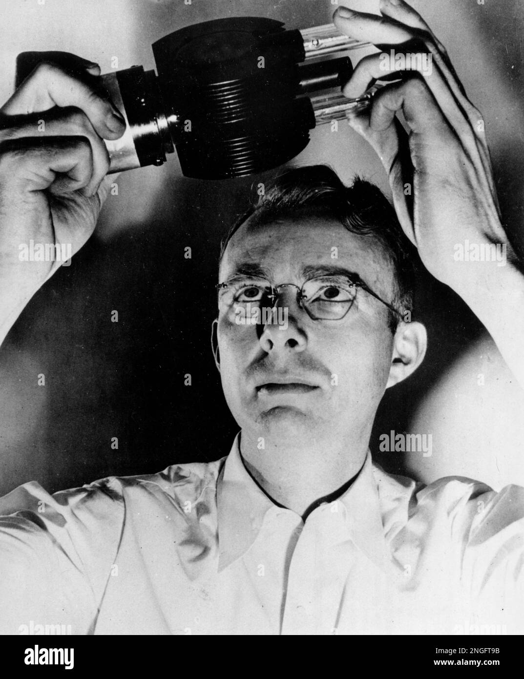 Scientist Dr. Luis Walter Alvarez examines a radio transmitter used in ...