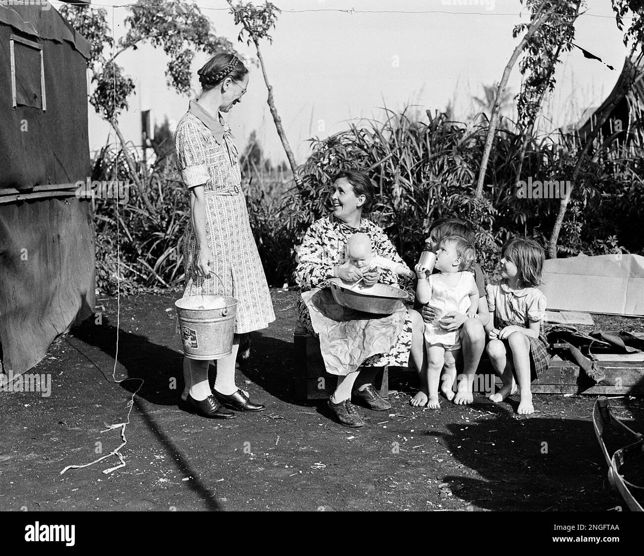 A family of migrant farm laborers are shown at their temporary home ...