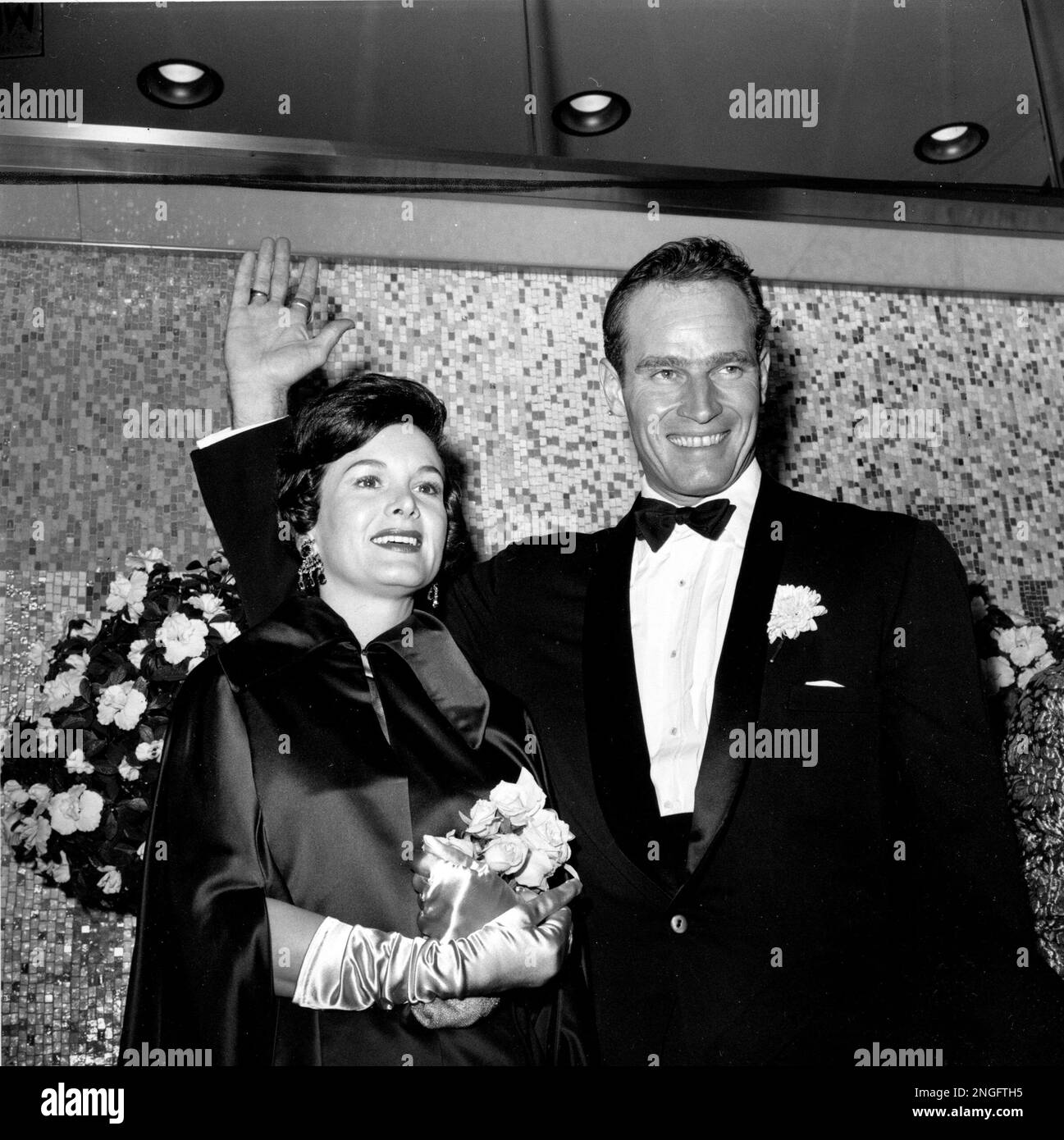 Actor Charlton Heston acknowledges fans as he arrives with his wife ...