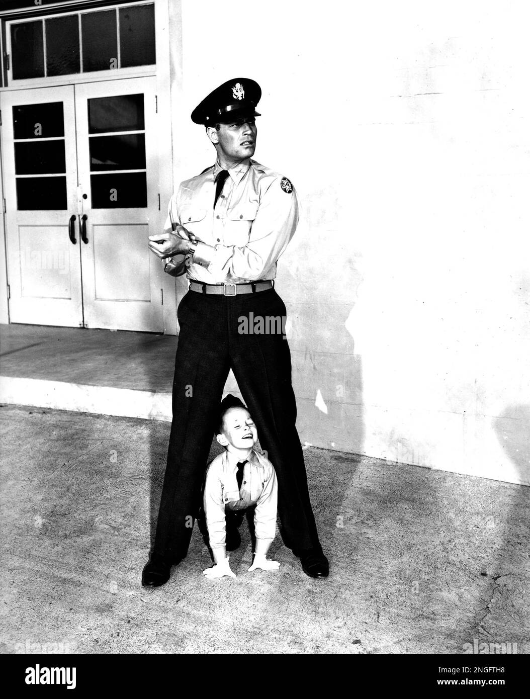 Actor Charlton Heston and child actor Tim Hovey appear in a scene from ...
