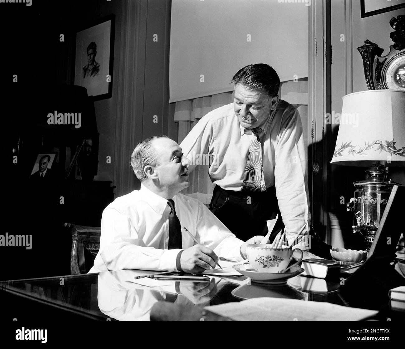 Richard Rodgers, seated, and Oscar Hammerstein II and are shown at work ...