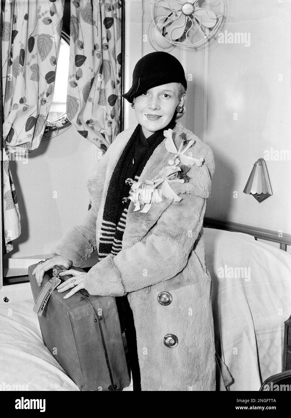 Actress Ann Harding is seen in her stateroom aboard the ocean liner ...