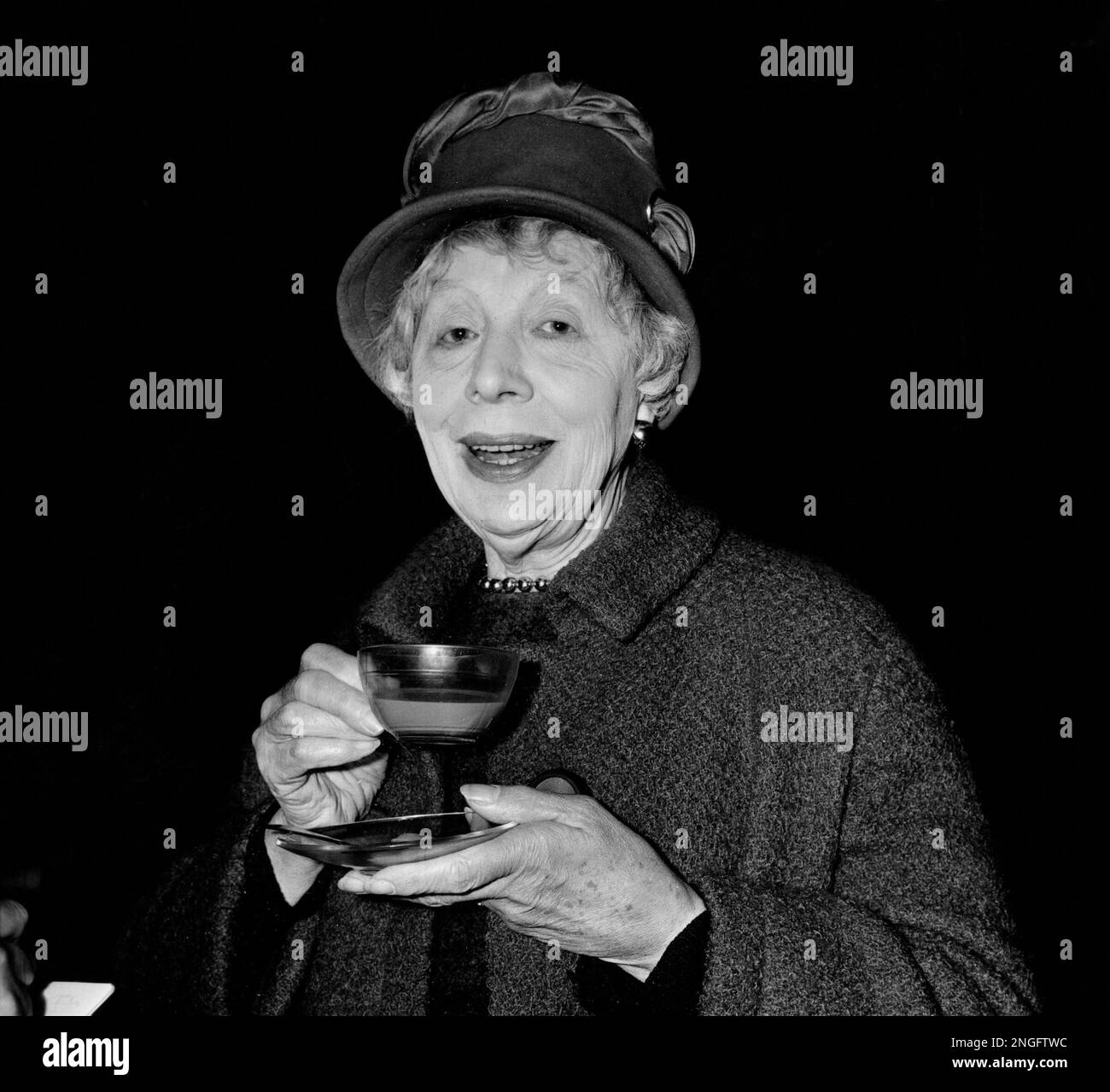 Dame Edith Evans enjoys a cup of tea during an interview at the London ...