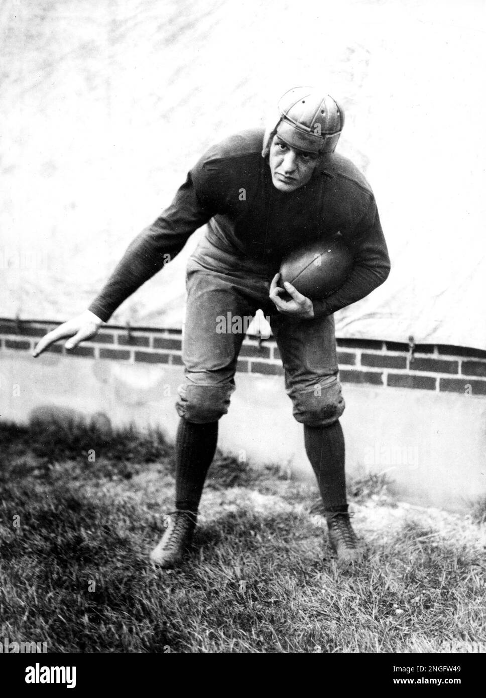 American football player Harold "Red" Grange is shown in an action pose ...