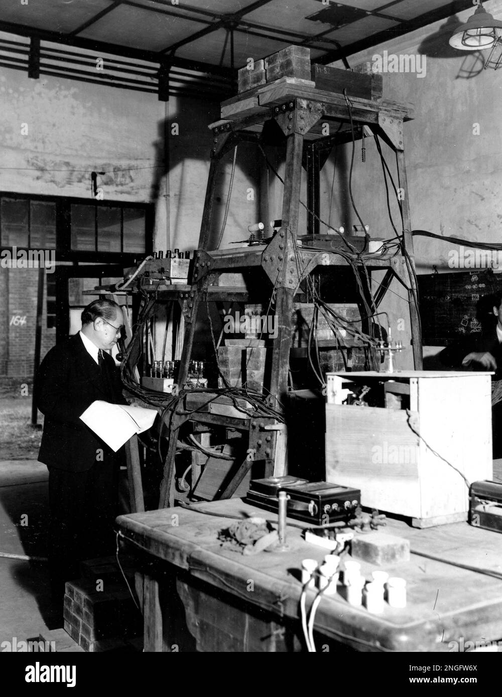 Nuclear physicist Dr. Yoshio Nishina checks the ionization chamber of ...