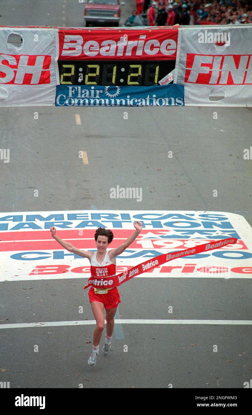 Joan Benoit Samuelson crosses the finish line to win first place in the women's division of the ...
